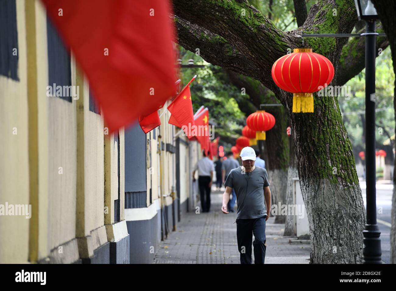 Red lanterns and national flags are seen flying along the Yihe street ...