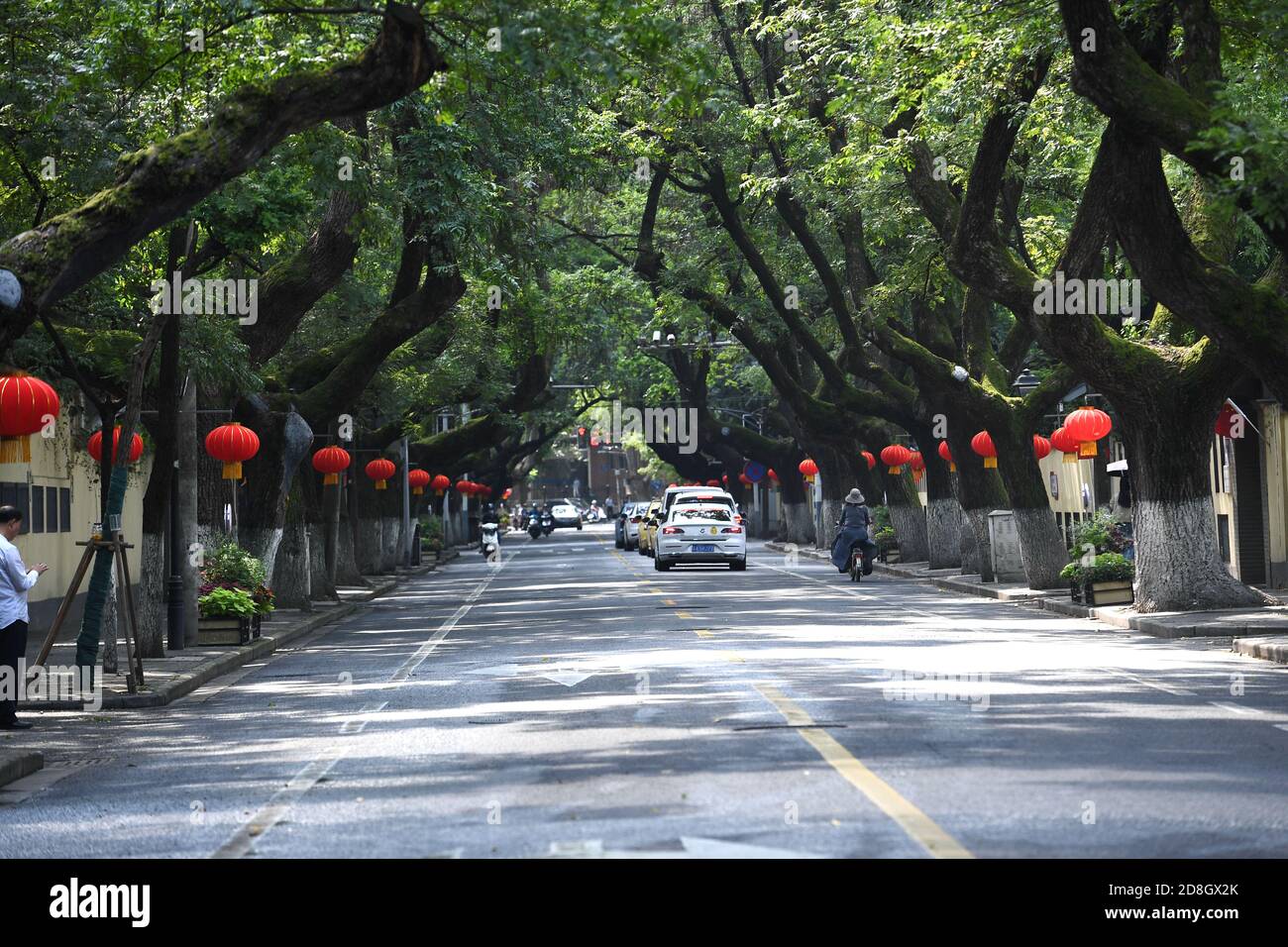 Red lanterns and national flags are seen flying along the Yihe street prior to the National Day ...