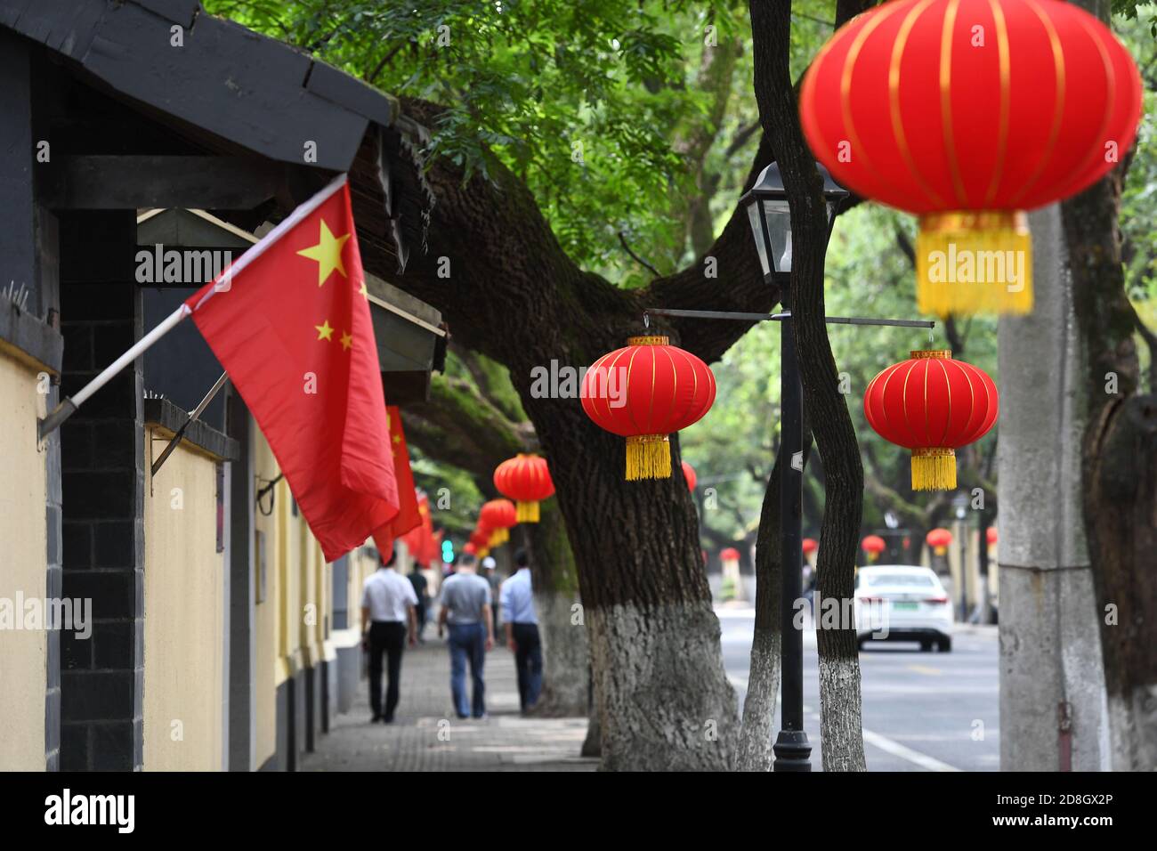 Red lanterns and national flags are seen flying along the Yihe street ...