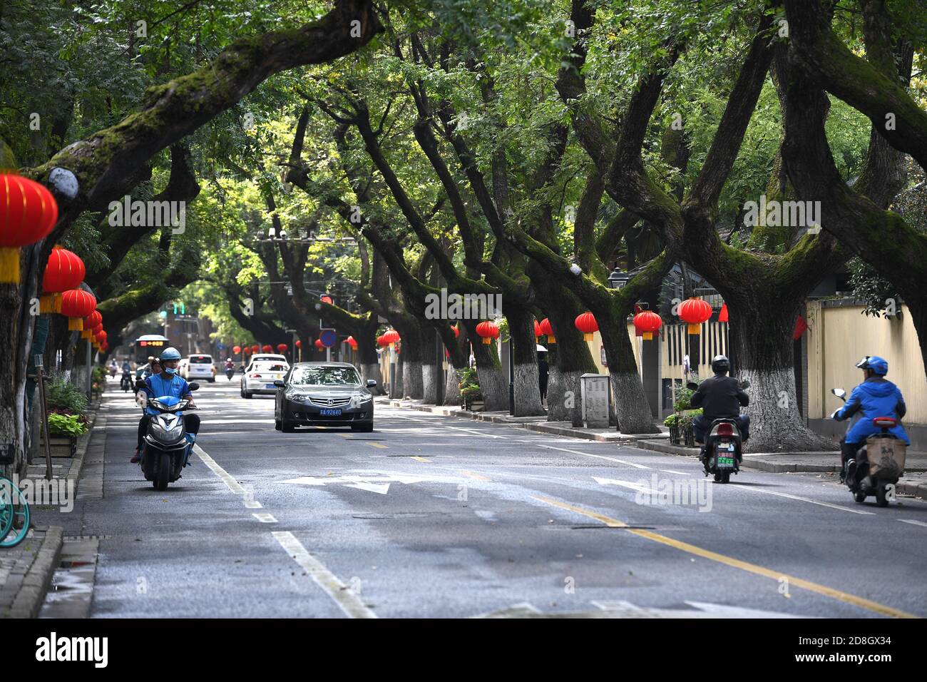 Red lanterns and national flags are seen flying along the Yihe street ...