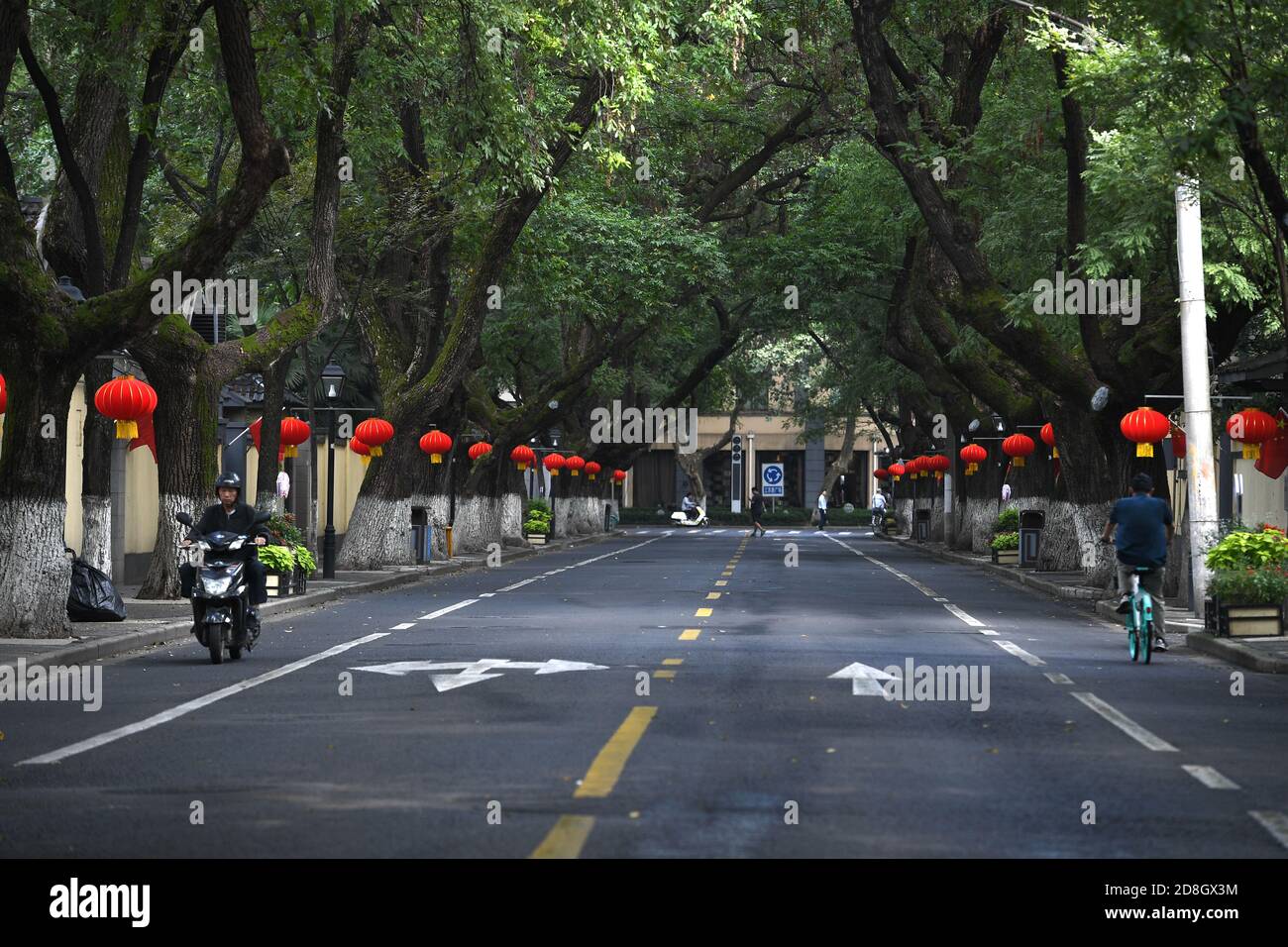 Red lanterns and national flags are seen flying along the Yihe street ...