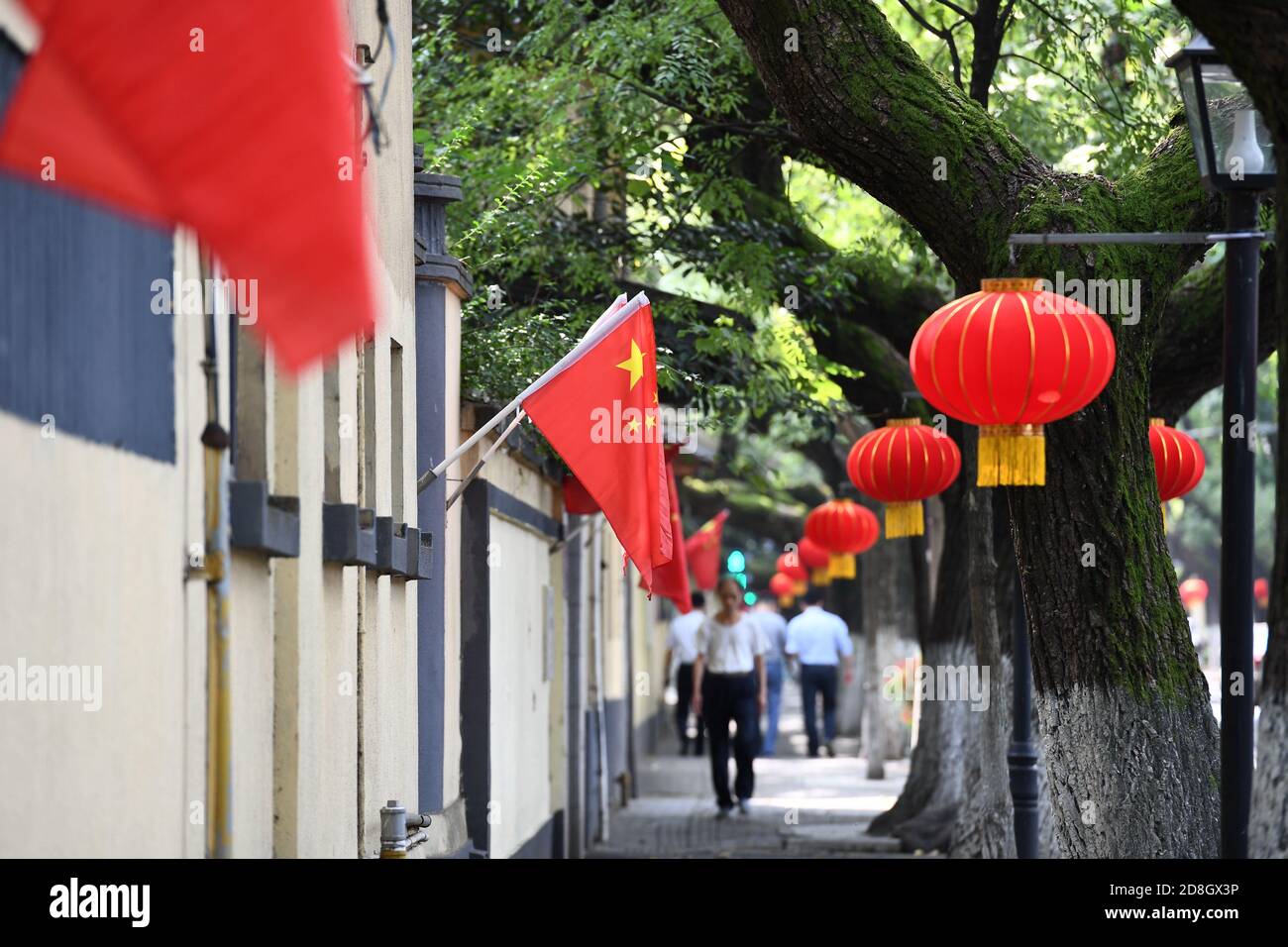 Red lanterns and national flags are seen flying along the Yihe street ...