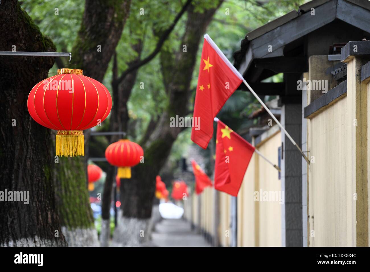 Red lanterns and national flags are seen flying along the Yihe street ...