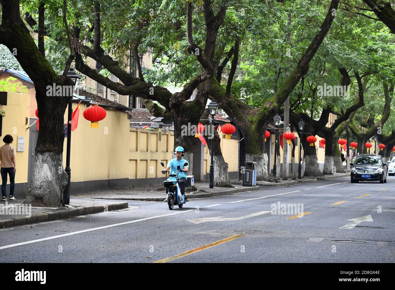 Red lanterns and national flags are seen flying along the Yihe street prior to the National Day ...