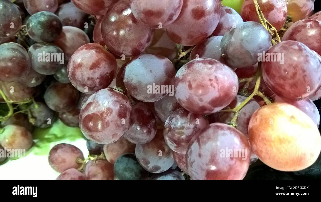 Closeup view of Red color Grapes fruit Stock Photo - Alamy