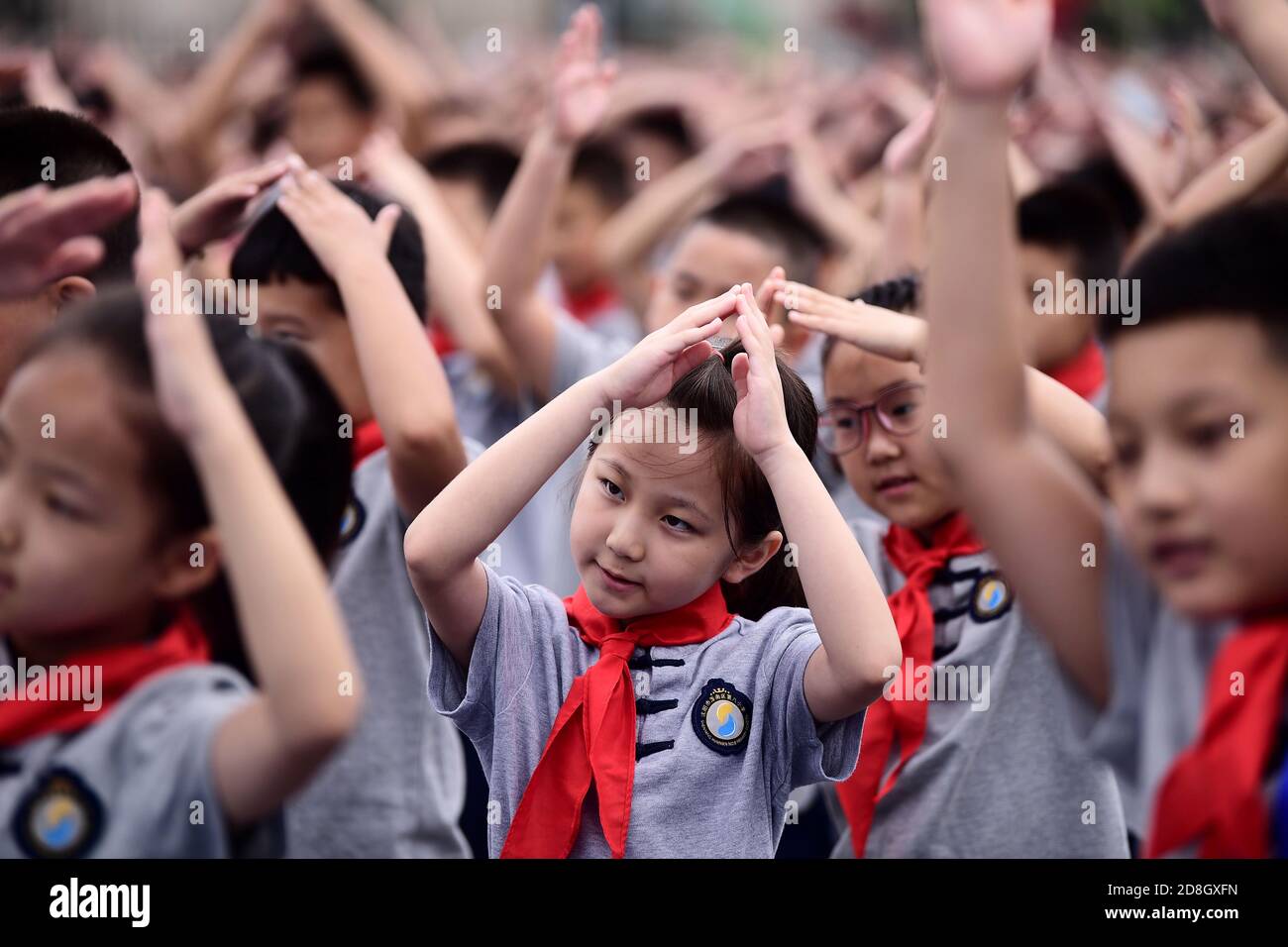 Students array on the playground, attending a ceremony to celebrate the ...