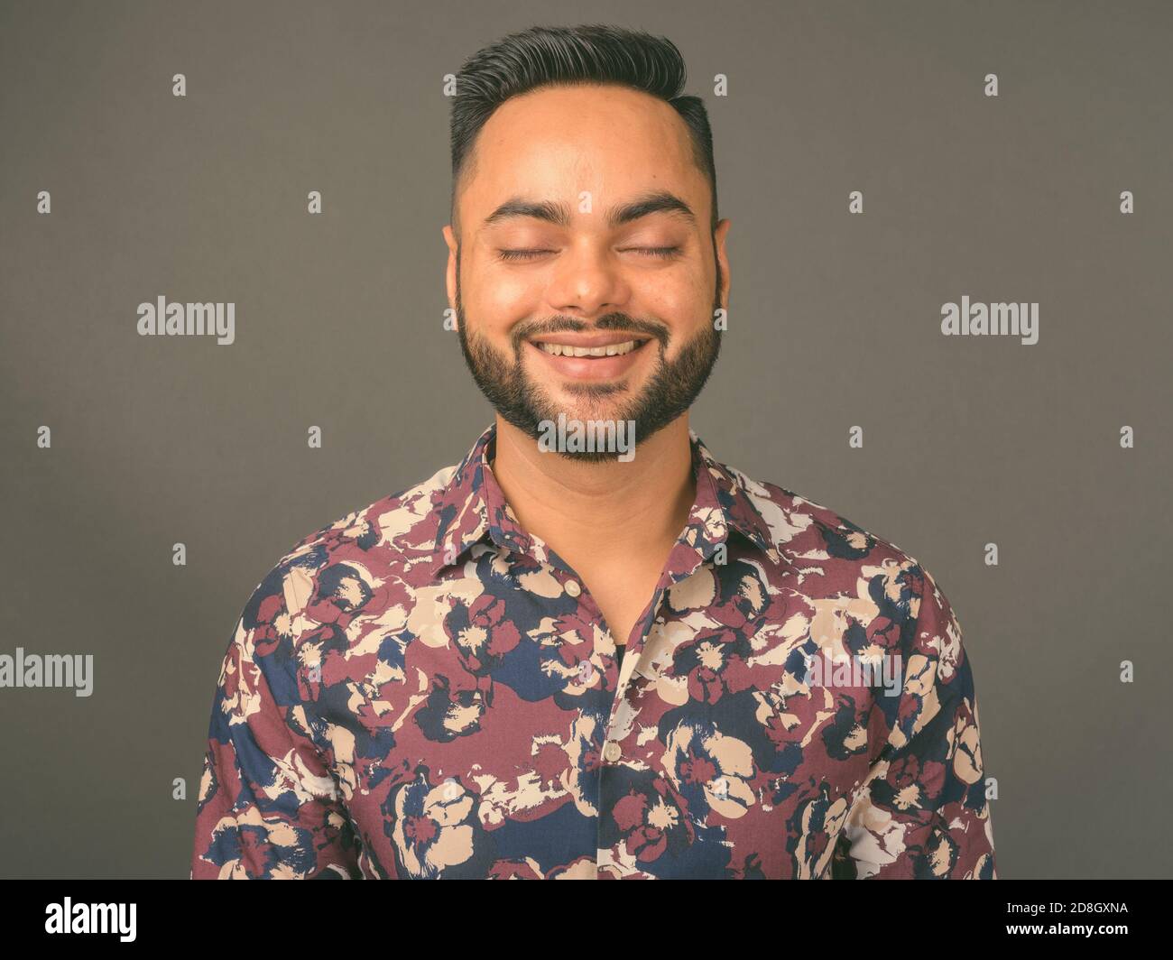 Young bearded Indian man against gray background Stock Photo - Alamy