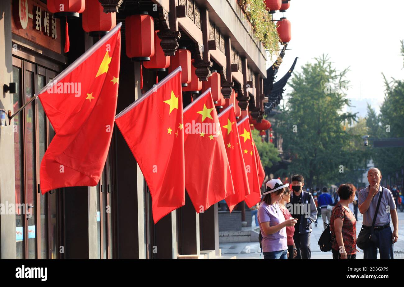 A line of Chinese national flags fly on the street prior to the ...