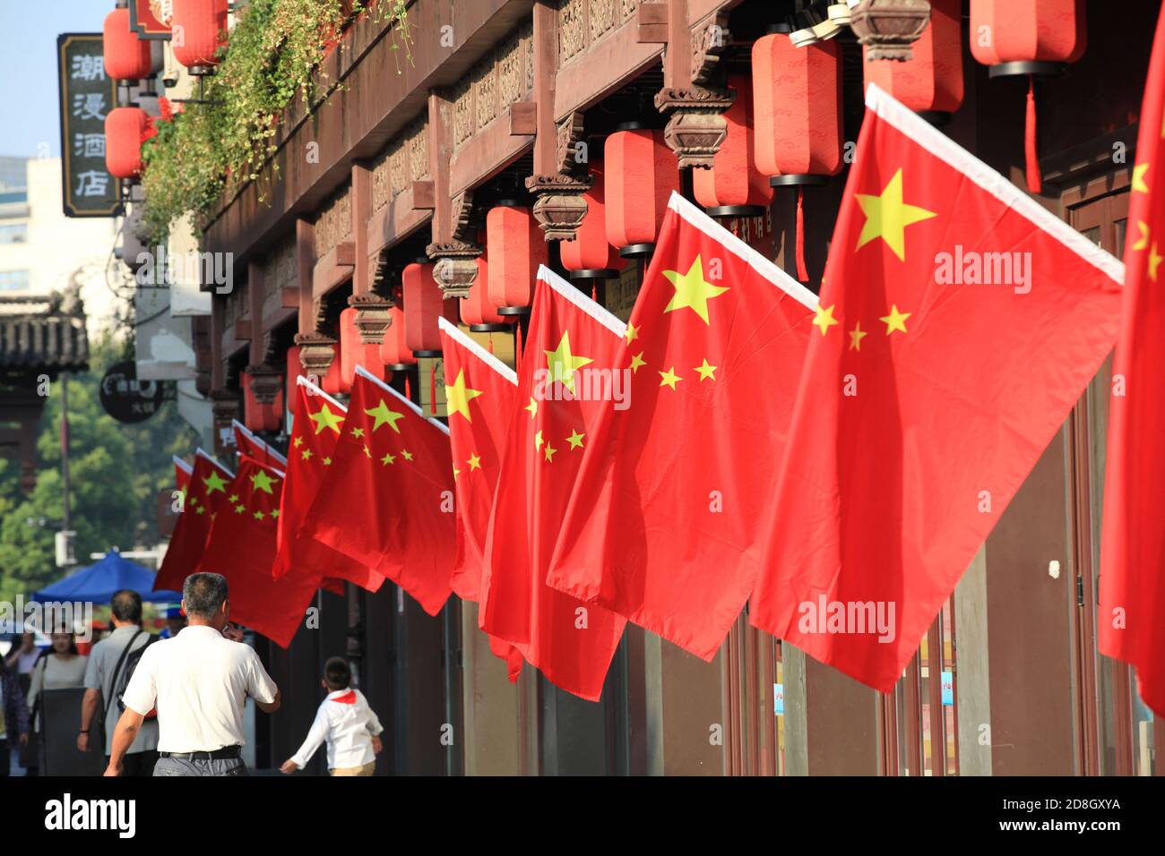 A line of Chinese national flags fly on the street prior to the ...