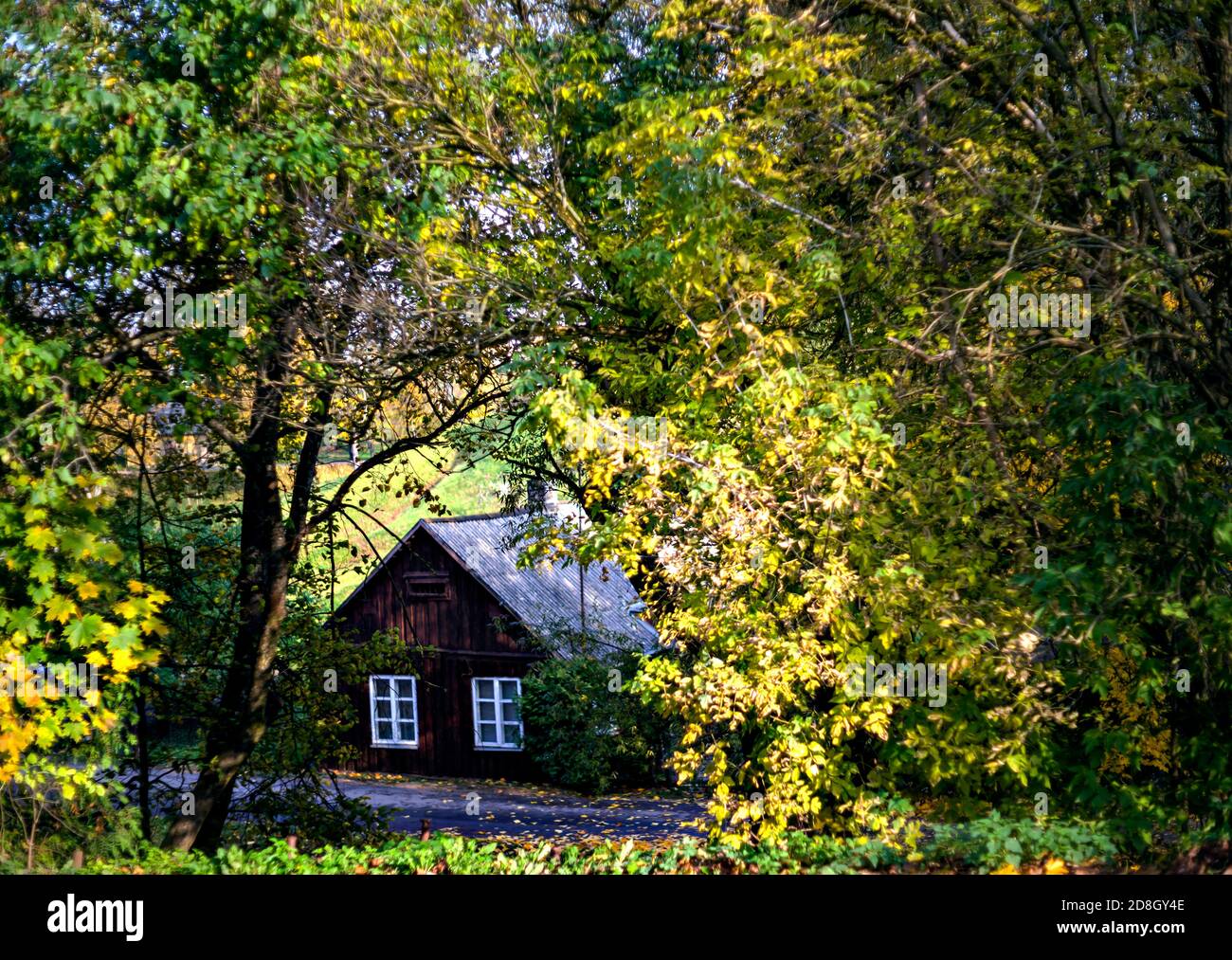 Defocused blurred autumn background with old house Stock Photo - Alamy