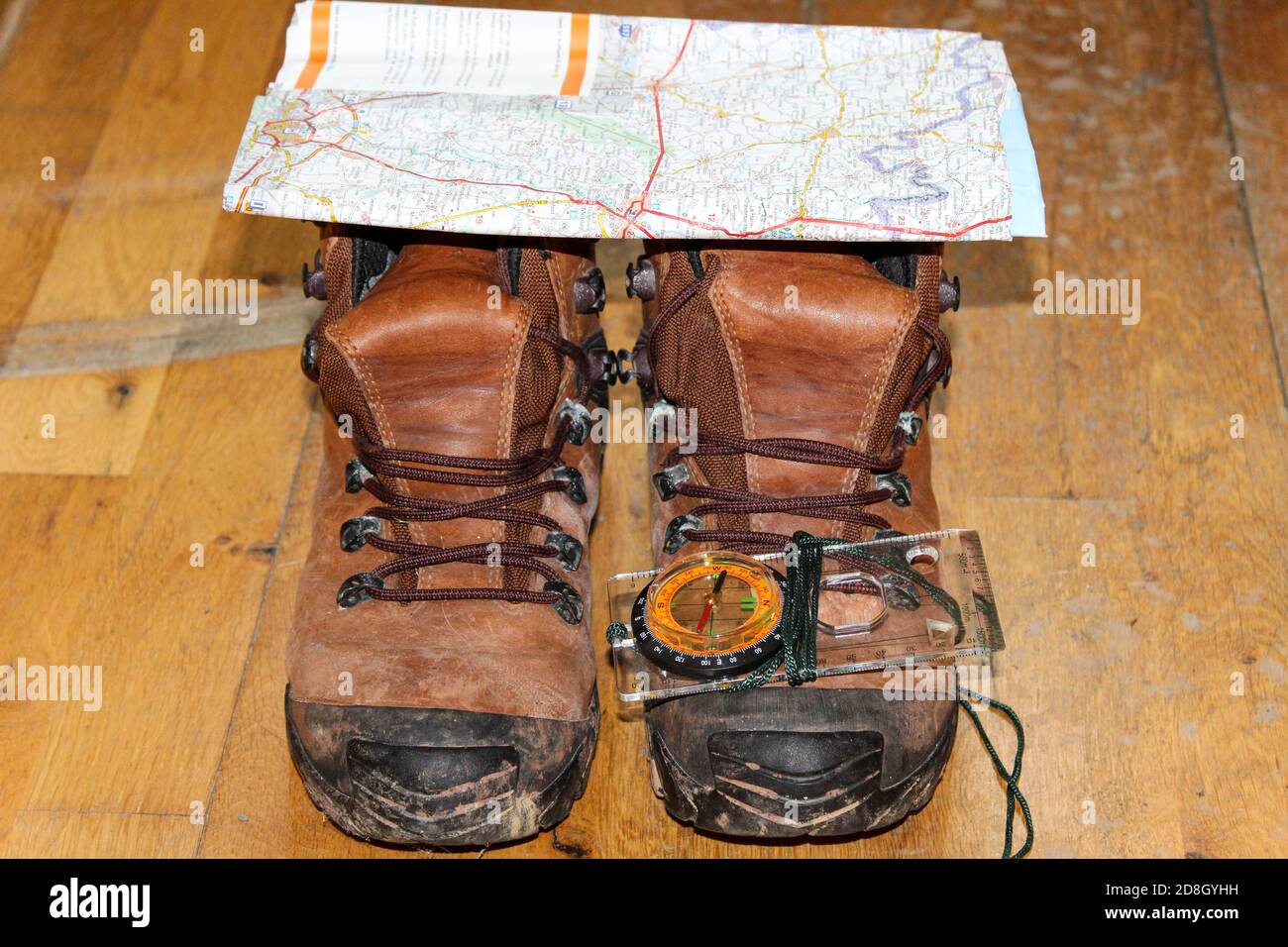 walking boots with map and compass Stock Photo - Alamy