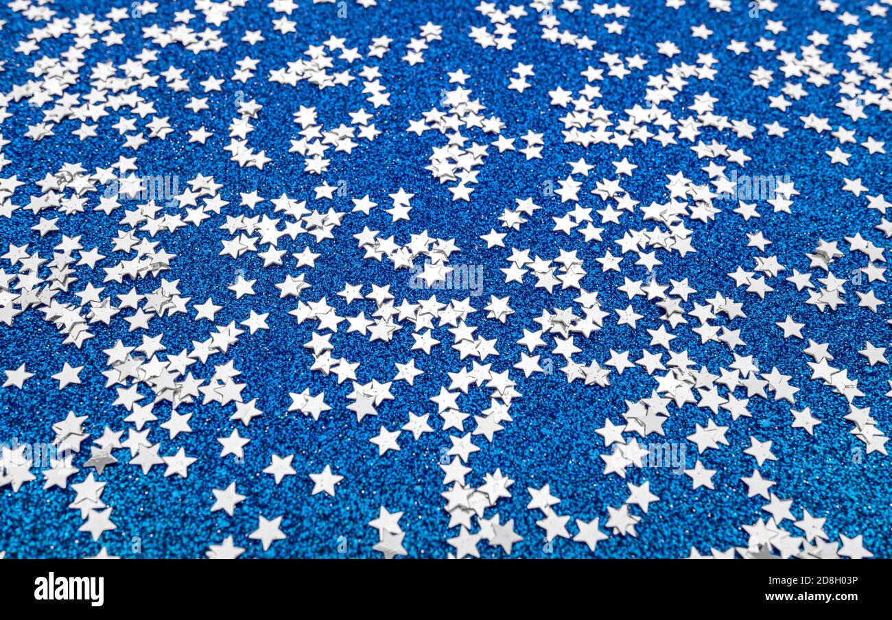 Scattered stars on a blue festive background Stock Photo - Alamy