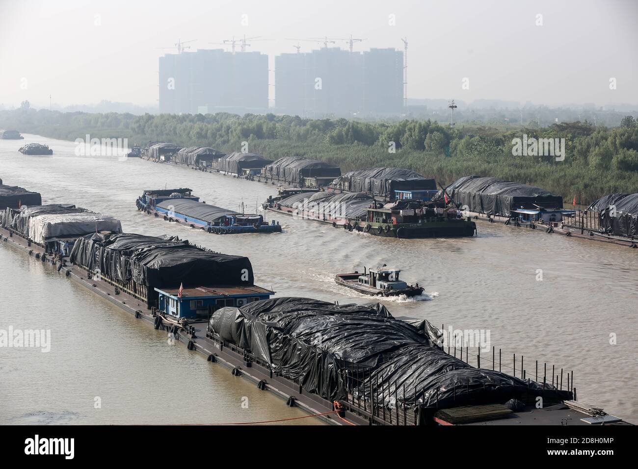 An aerial view of ships containing various kinds of goods moving on the ...