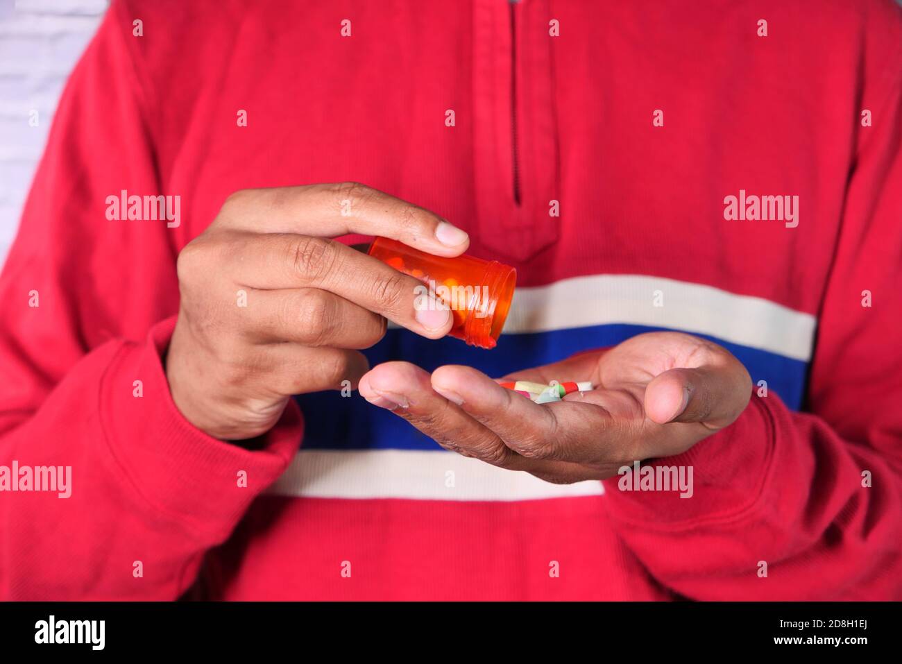 Close up of man hand taking medicine Stock Photo - Alamy