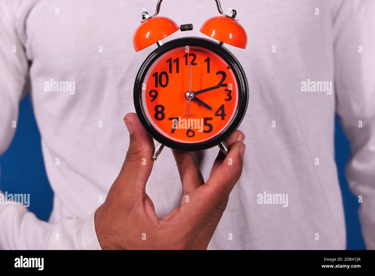close up of hand holding alarm clock Stock Photo - Alamy