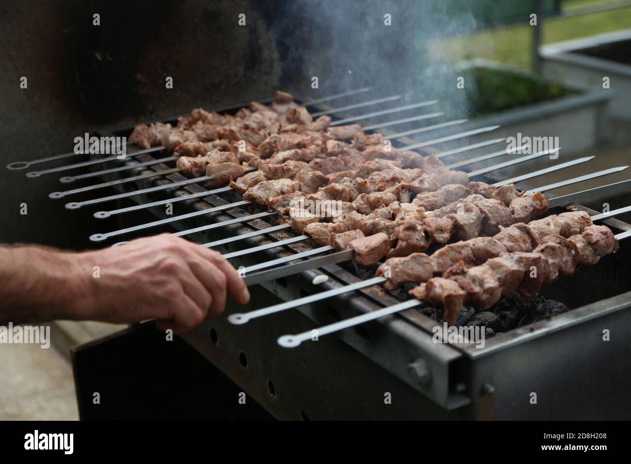 Roasted meat cooked at barbecue with smoke. Traditional eastern dish ...
