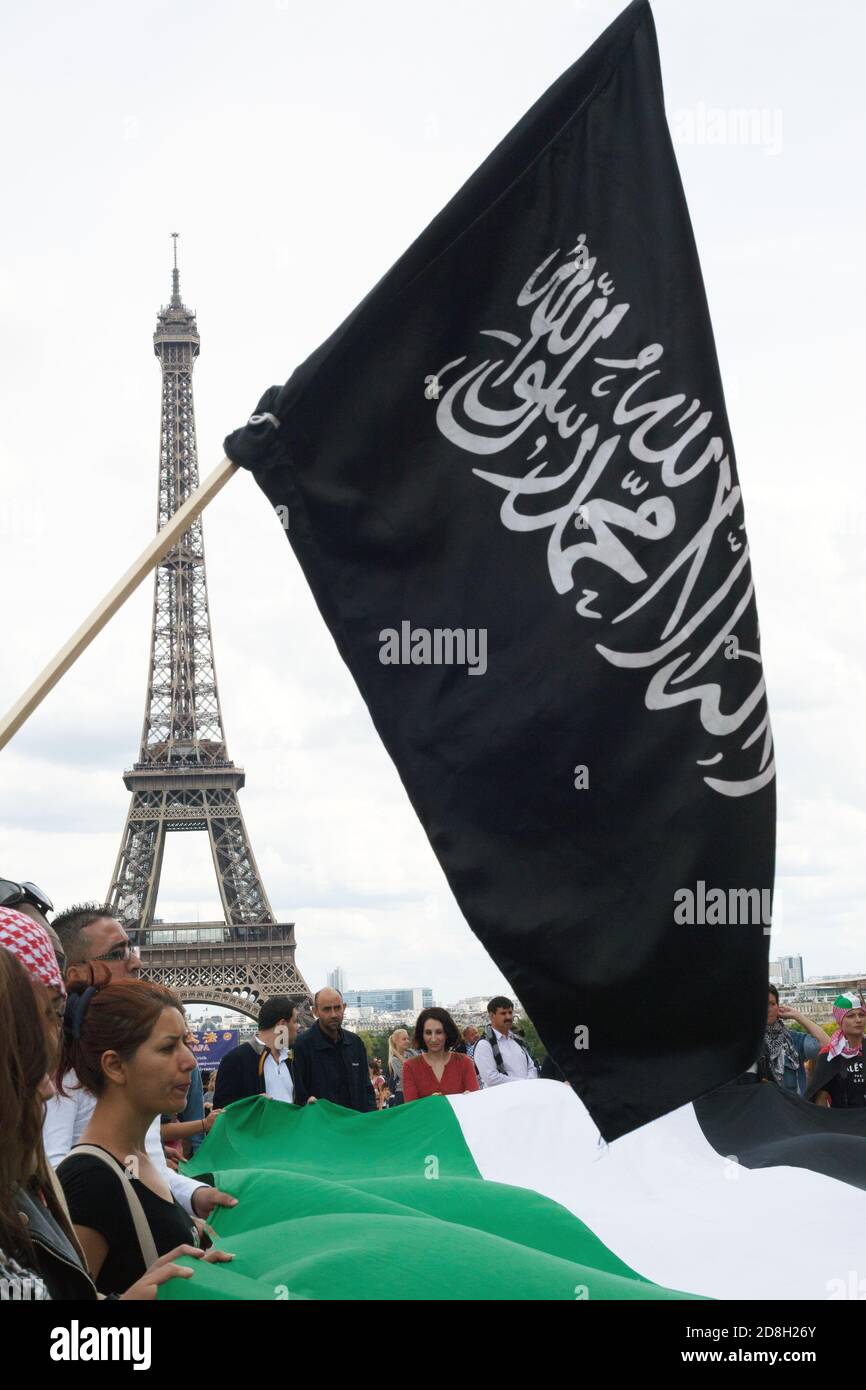 Daeh black flag of the Islamic state in front of the eiffel tower in a ...