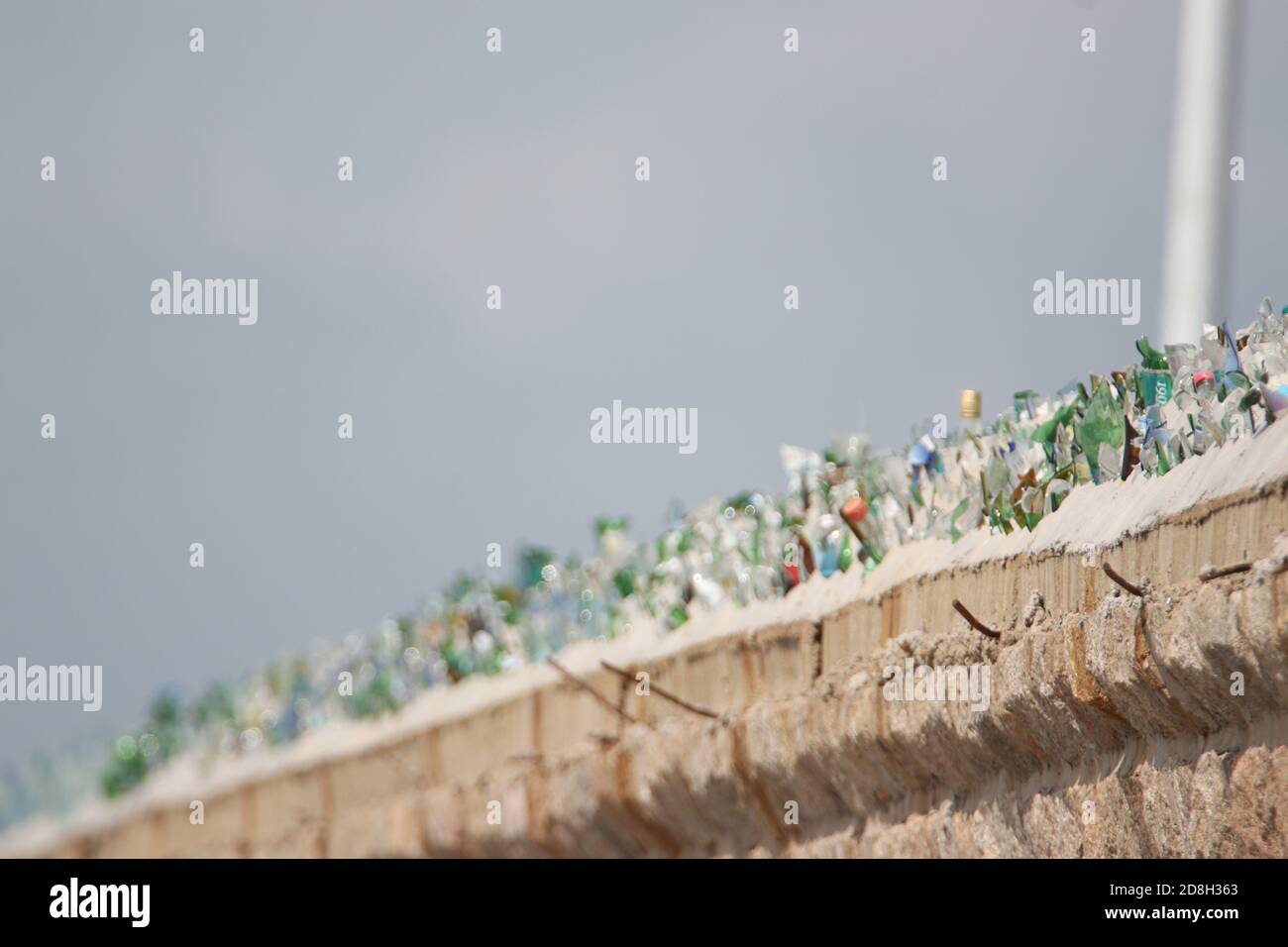 A wall's top was filled with hundreds of meters of glass shards to ...