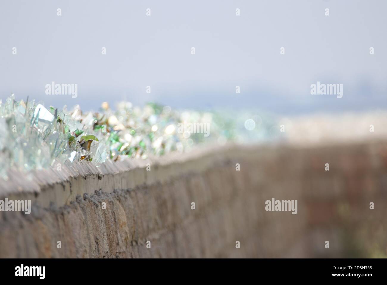 A wall's top was filled with hundreds of meters of glass shards to ...