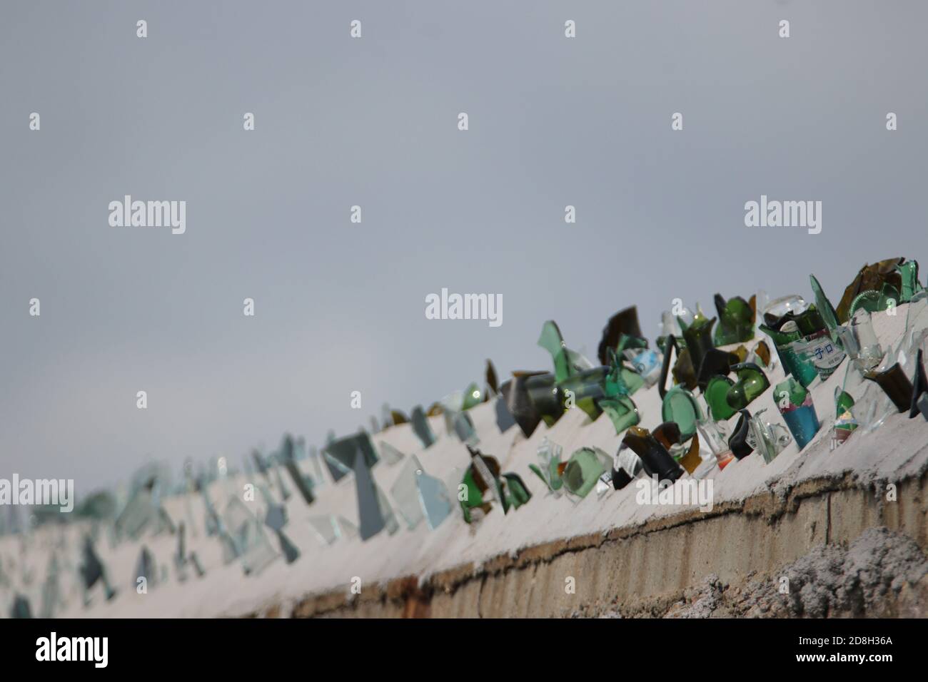 A wall's top was filled with hundreds of meters of glass shards to ...