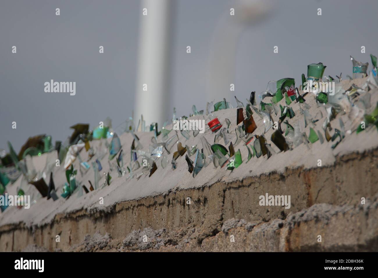 A wall's top was filled with hundreds of meters of glass shards to ...