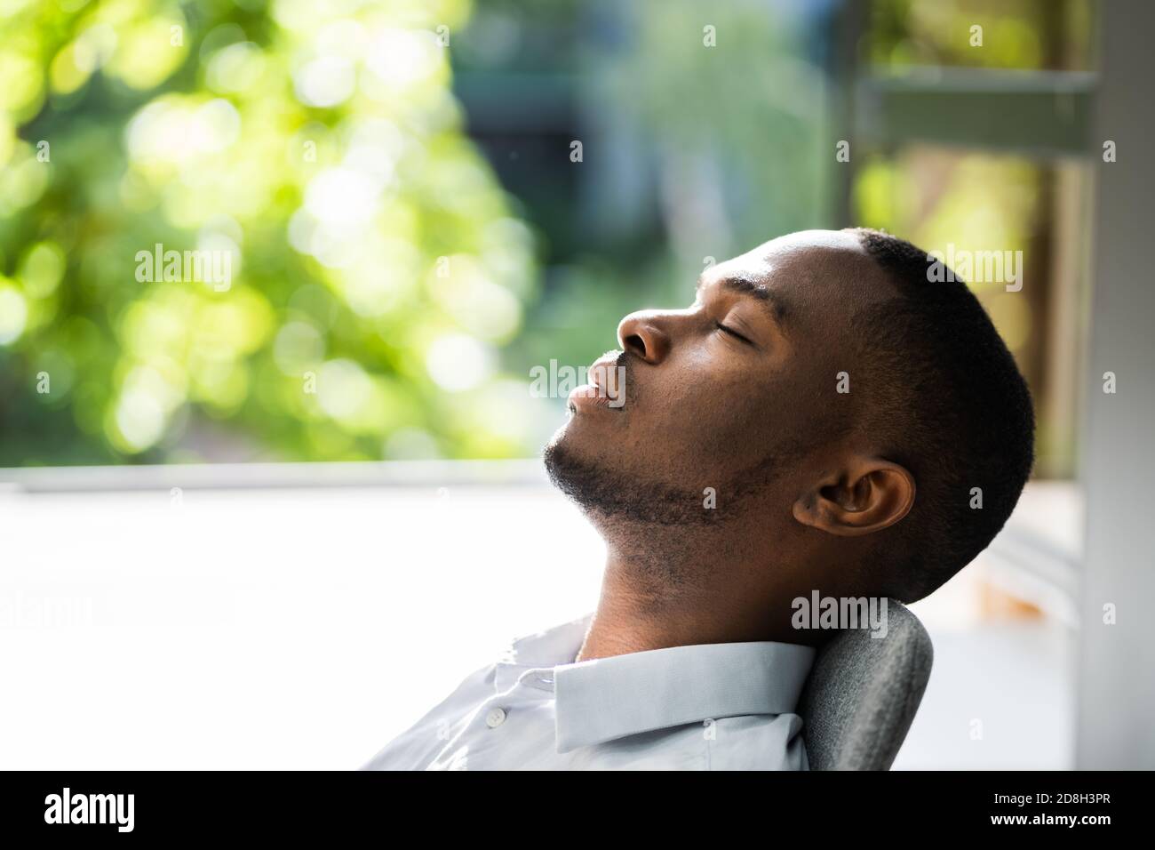 Fresh Air At Desk In Office African American Relaxing Near Window Stock ...