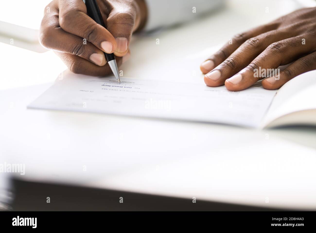 Signing cheques hi-res stock photography and images - Alamy
