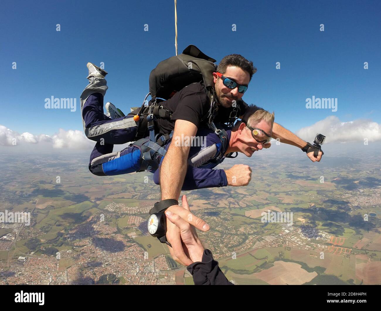 Skydiving tandem hands shake Stock Photo - Alamy