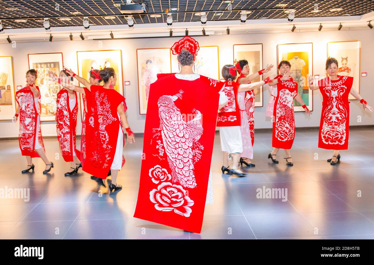 Elder models present papercut qipao or Chinese long gown at Shenyang ...