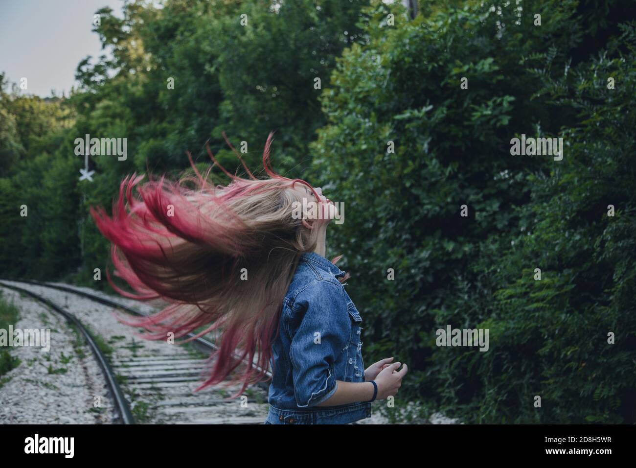 Flying long hair blonde girl in nature. The hair is blonde with pink ...