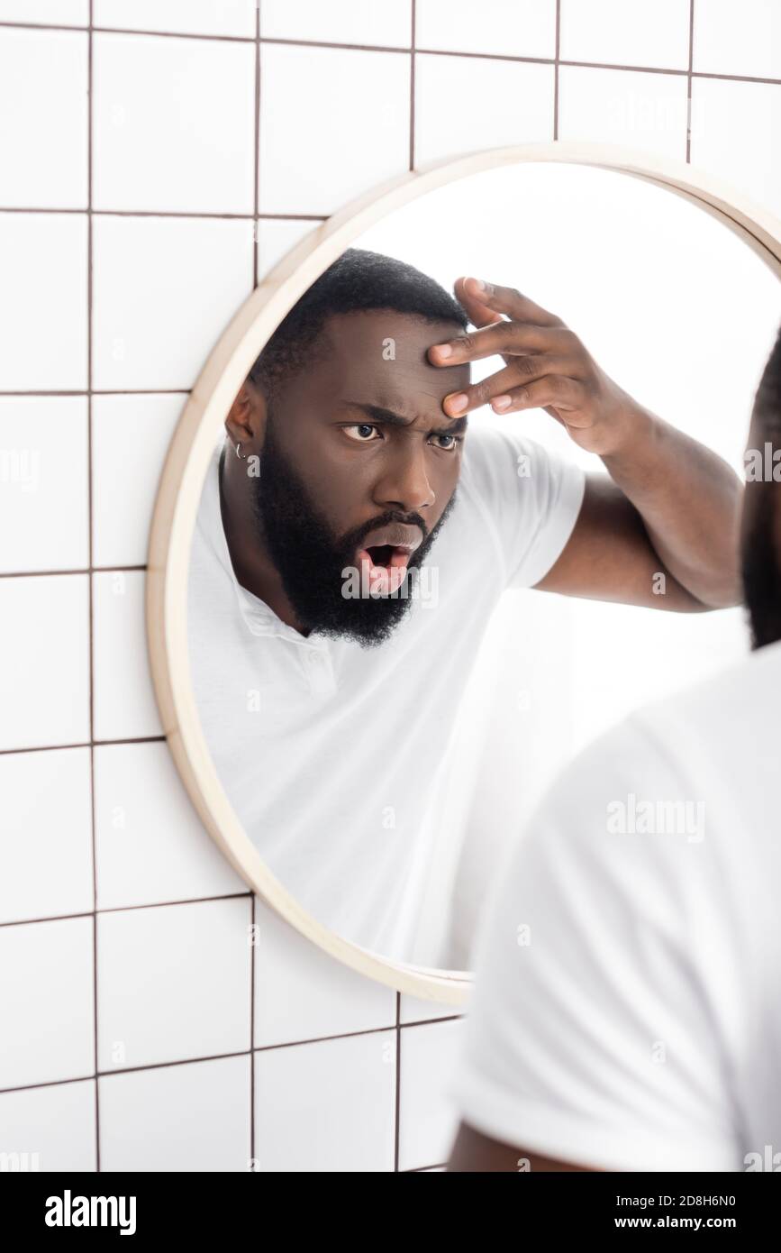 Shocked looking in mirror hi-res stock photography and images - Alamy