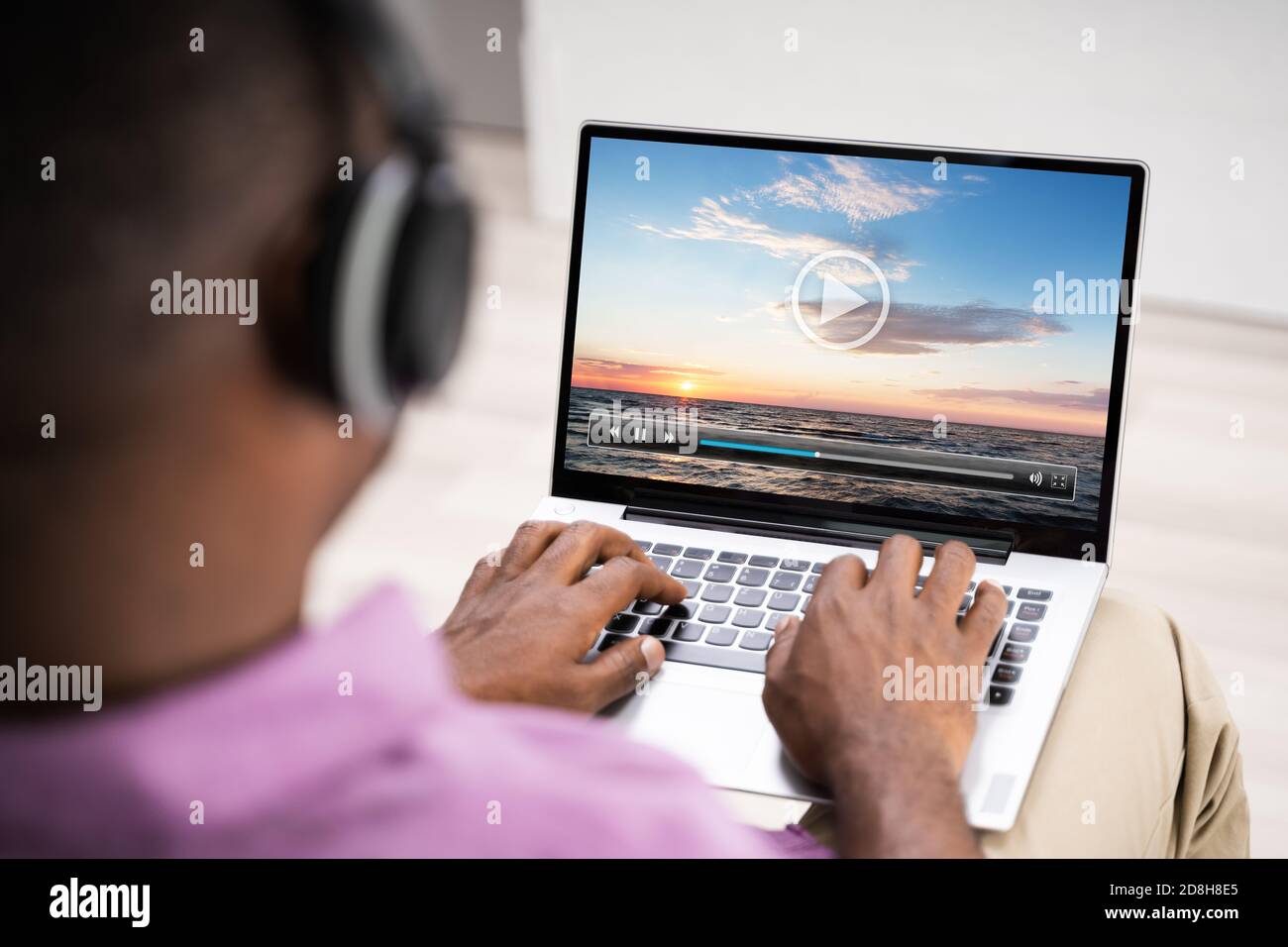 Young African Man Watching Video On Laptop Stock Photo - Alamy