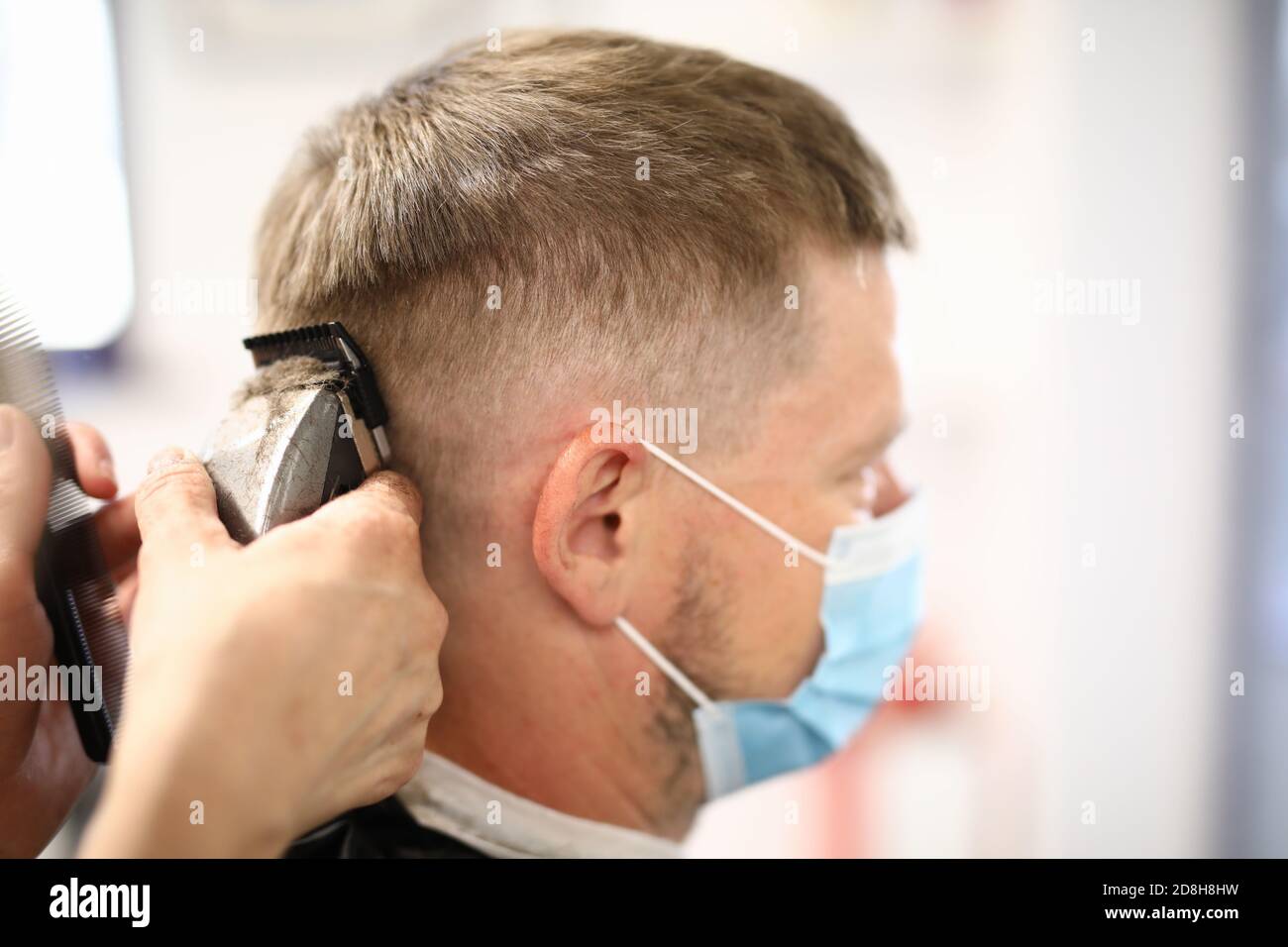 Man gets haircut in mask hi-res stock photography and images - Alamy