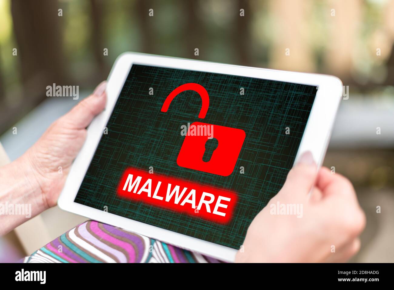 Female hands holding a tablet with malware concept Stock Photo - Alamy