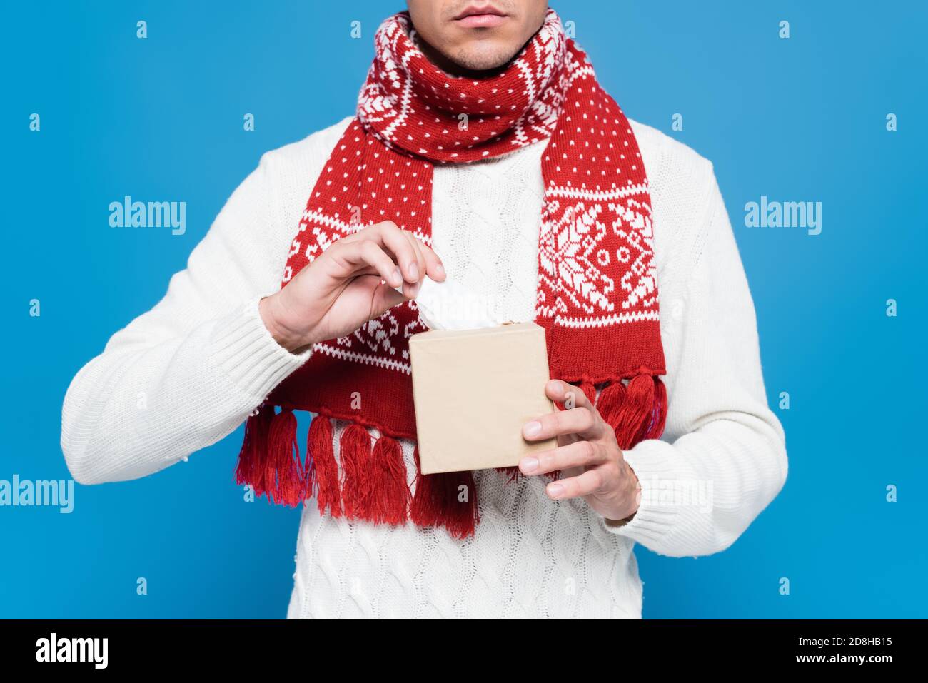 Cropped view of sick man taking tissues from box isolated on blue Stock ...