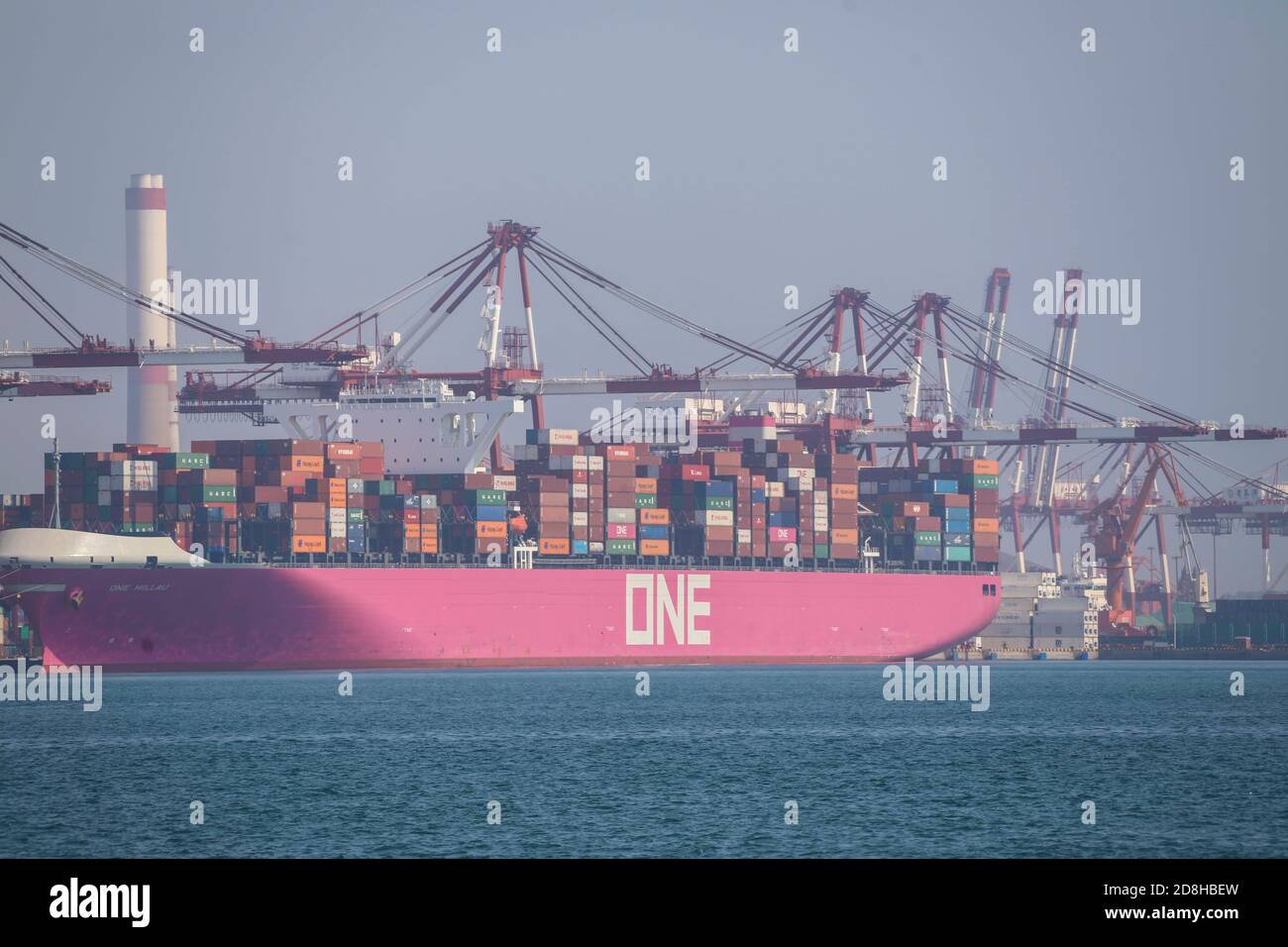 A pink container cargo ship dock on the Qingdao Qianwan Container ...
