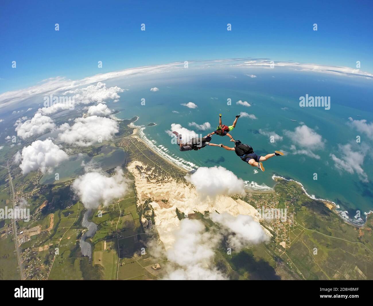 A group of skydiving friends having fun in the skies. Soft focus in ...