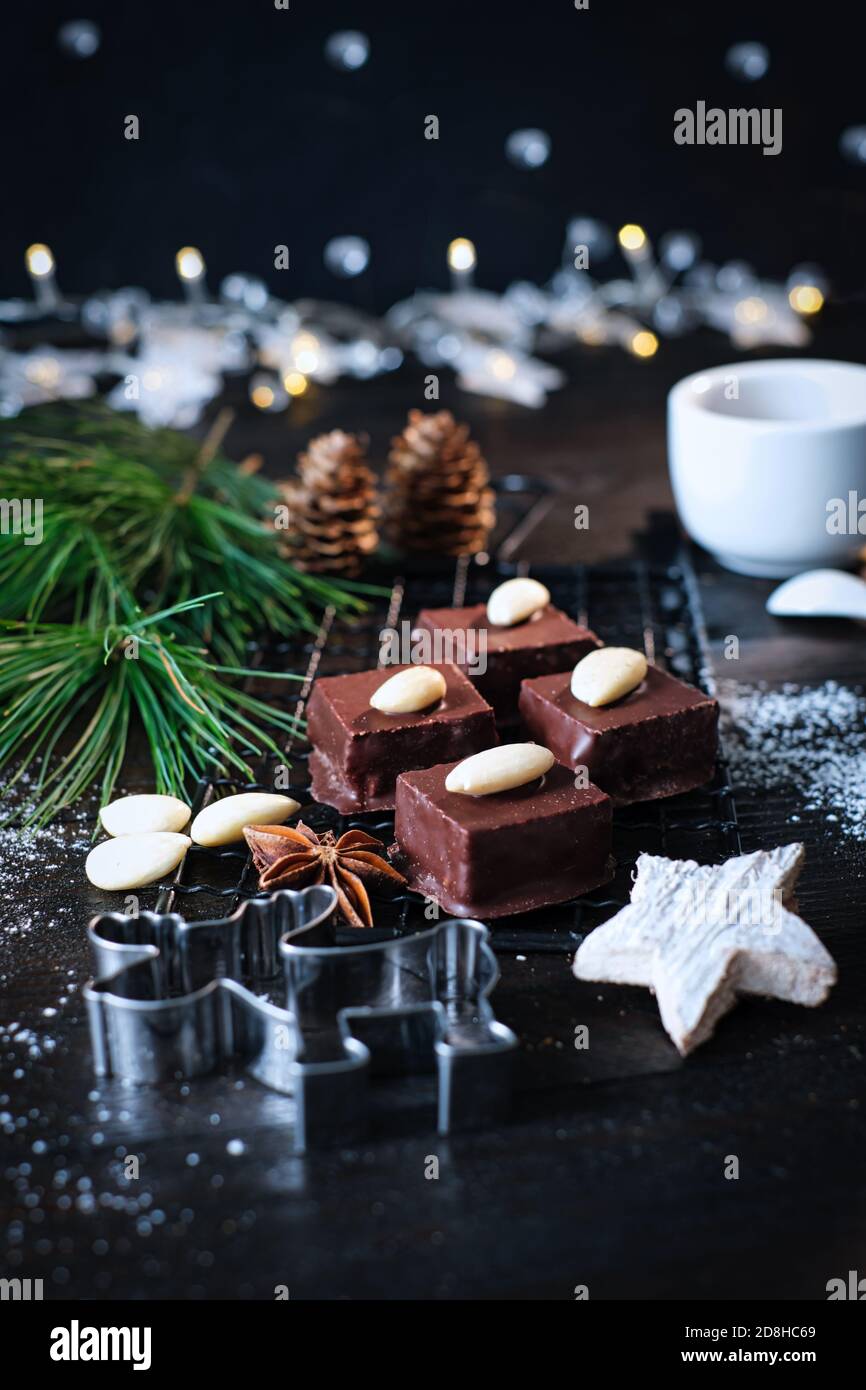 Marzipancubes with chocolate icing on a black cooling grid, decorated ...