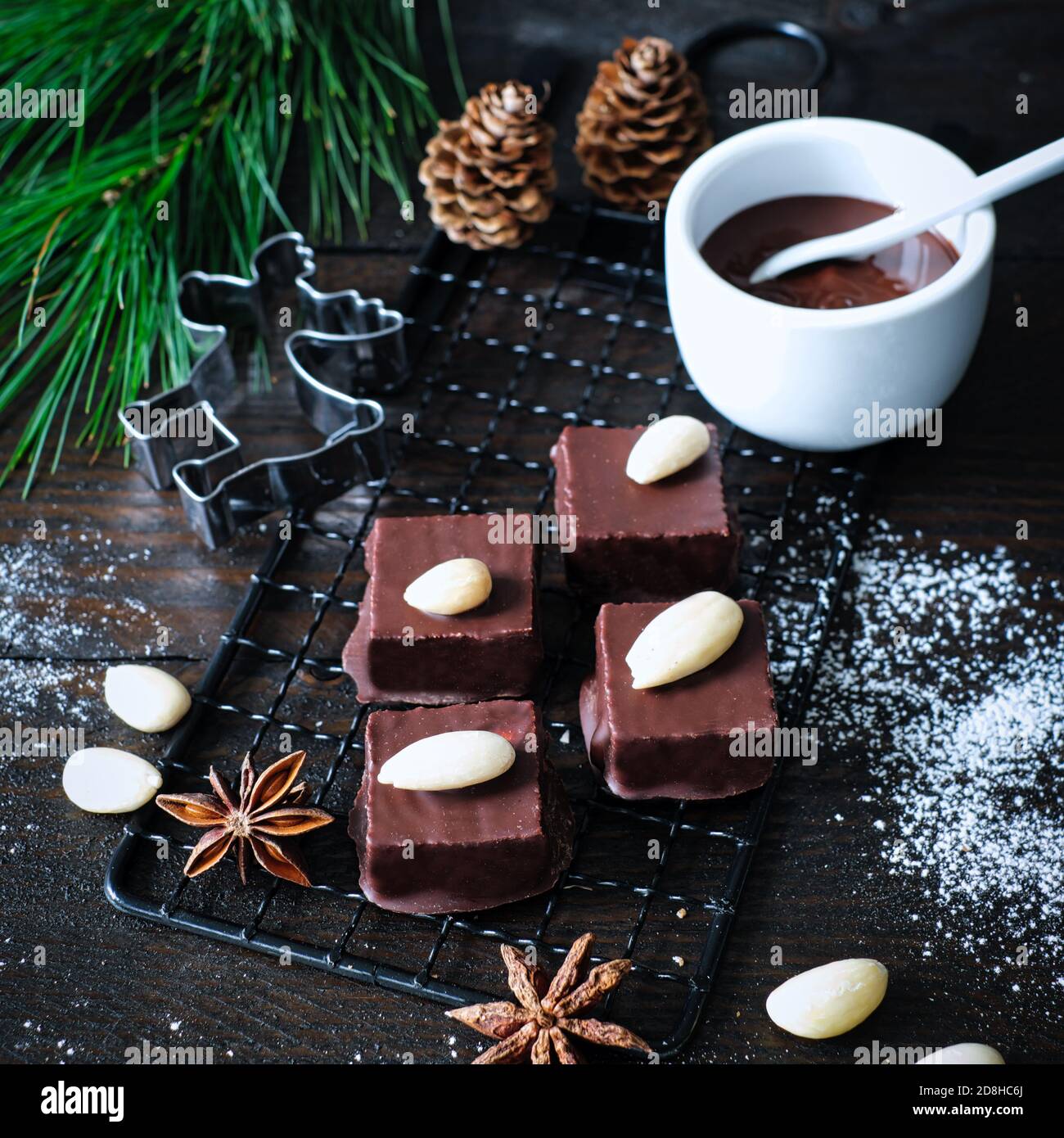 Marzipancubes with chocolate icing on a black cooling grid, decorated ...