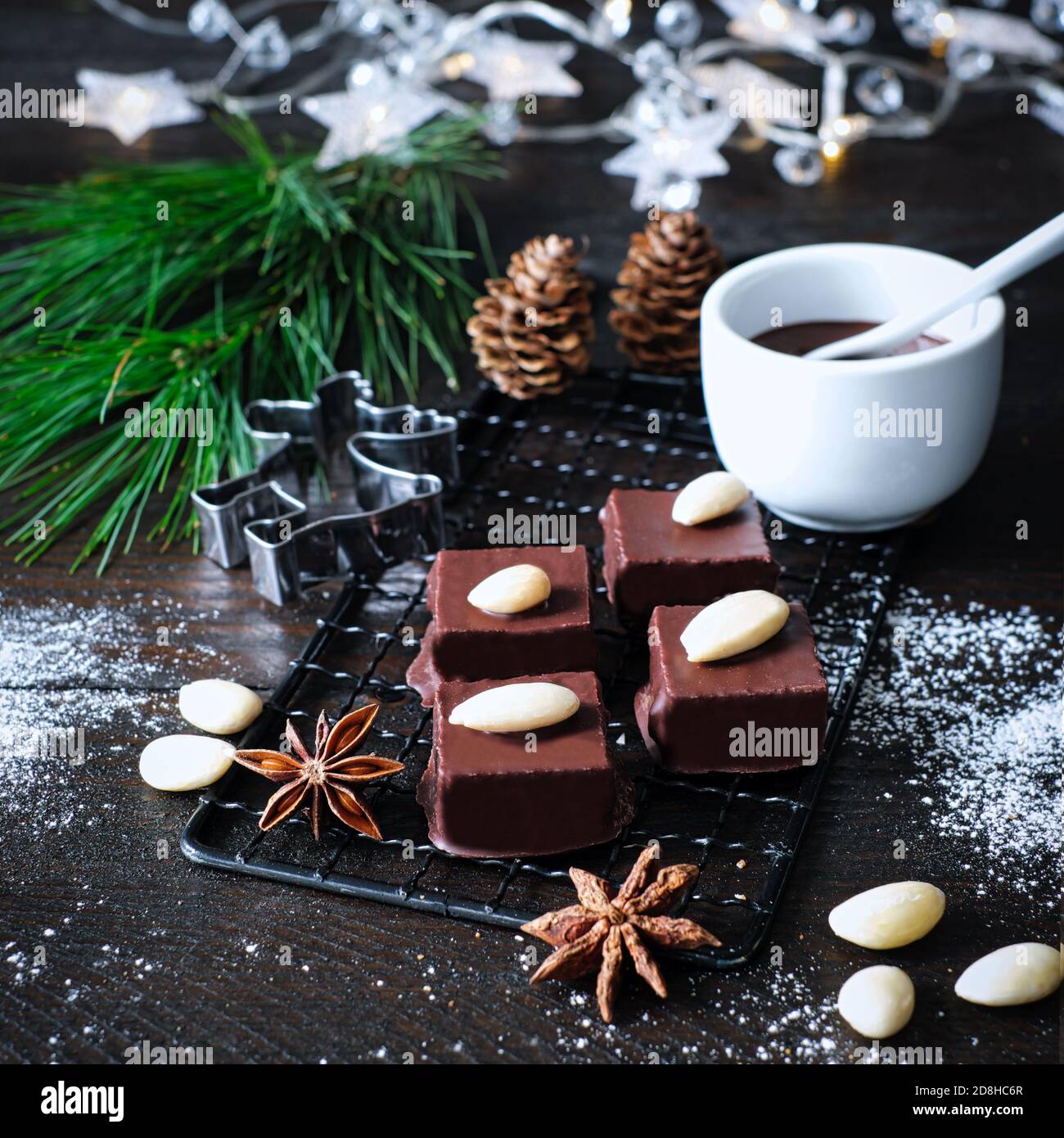 Marzipancubes with chocolate icing on a black cooling grid, decorated ...