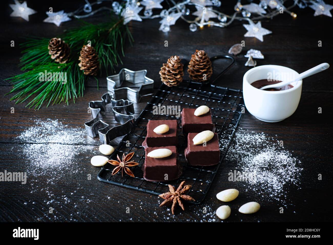 Marzipancubes with chocolate icing on a black cooling grid, decorated ...
