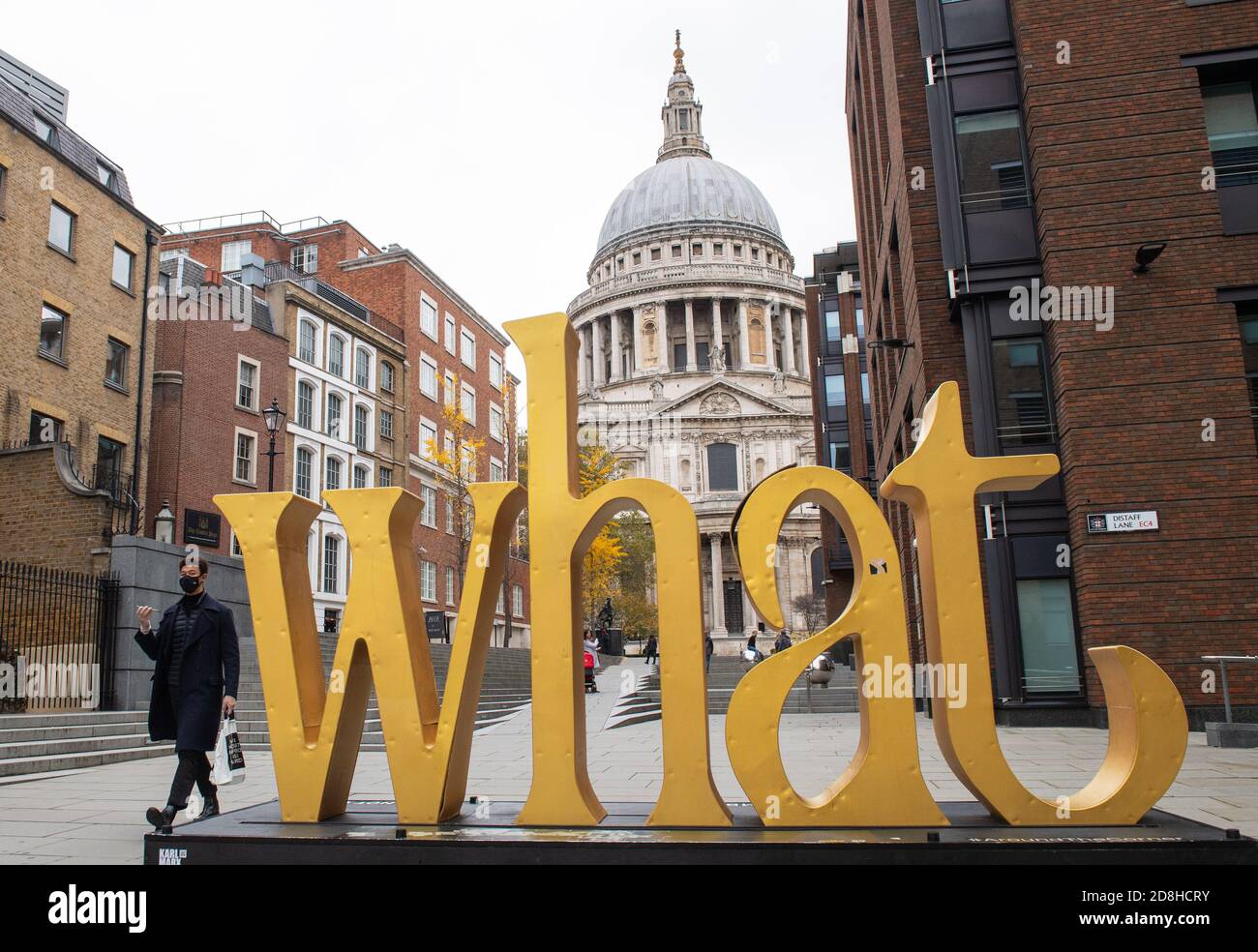 A man wearing a face mask walks near St Paul's Cathedral, in central ...
