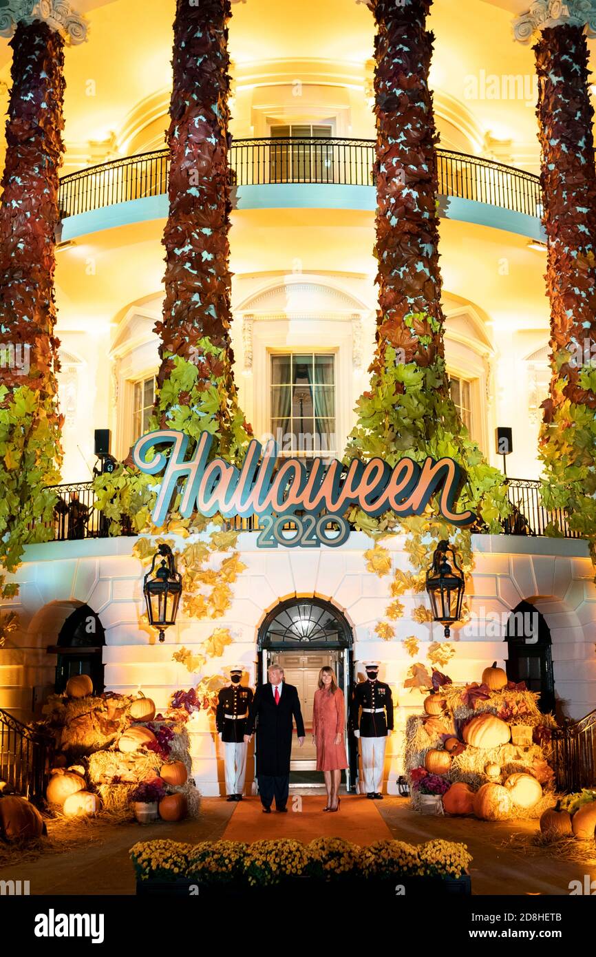 U.S. President Donald Trump and First Lady Melania Trump greet trick-or ...