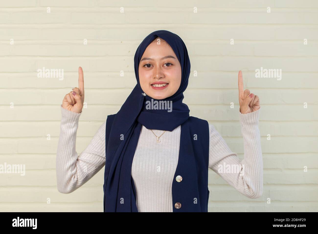 Asian muslim hijab woman with hand point on empty space Stock Photo - Alamy
