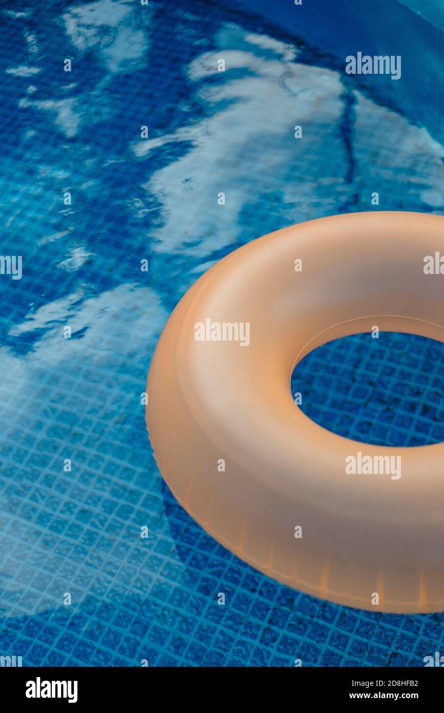 An orange pool ring in a swimming pool Stock Photo - Alamy