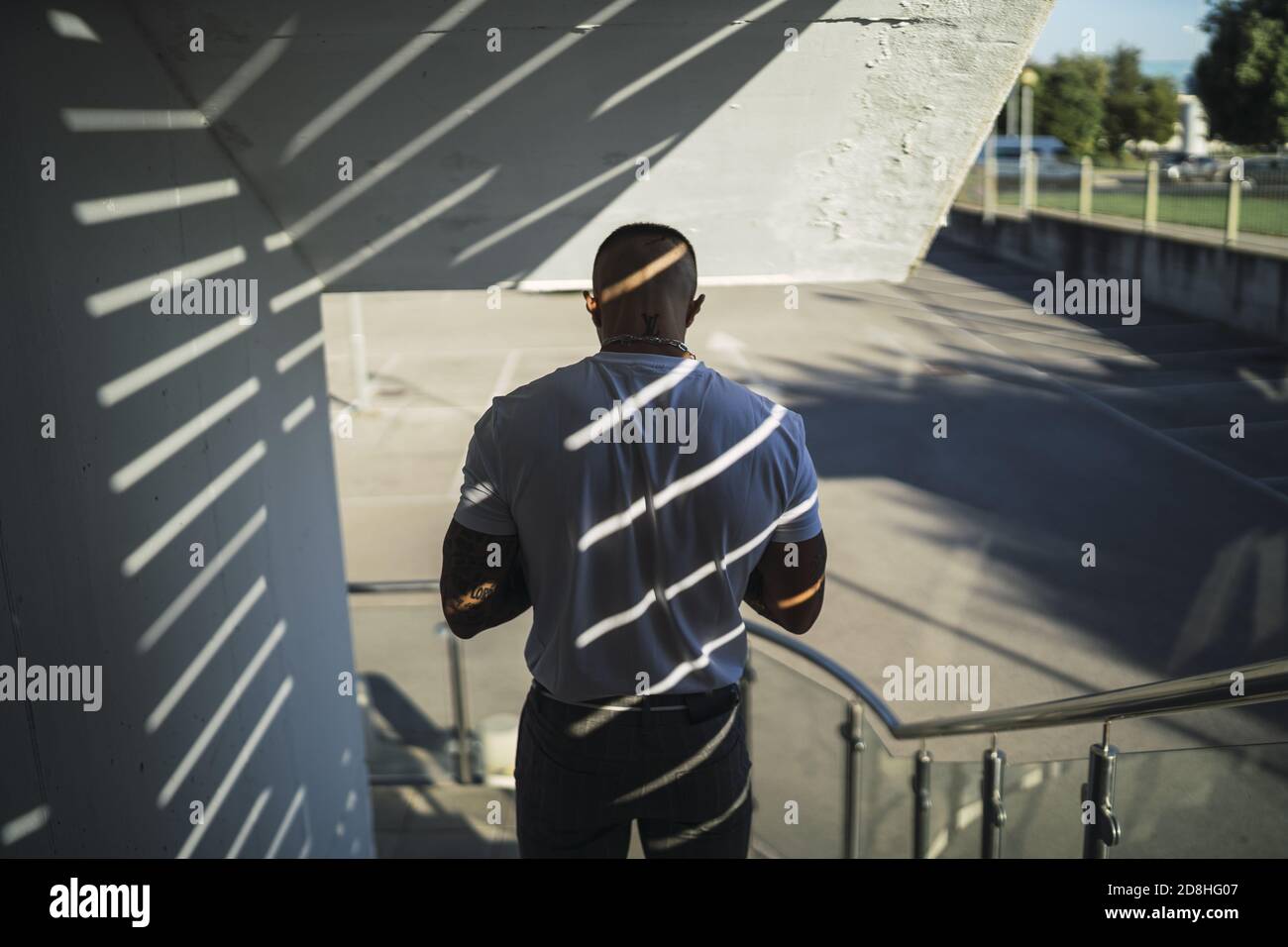 Back view of a man with shadows falling on his back Stock Photo - Alamy