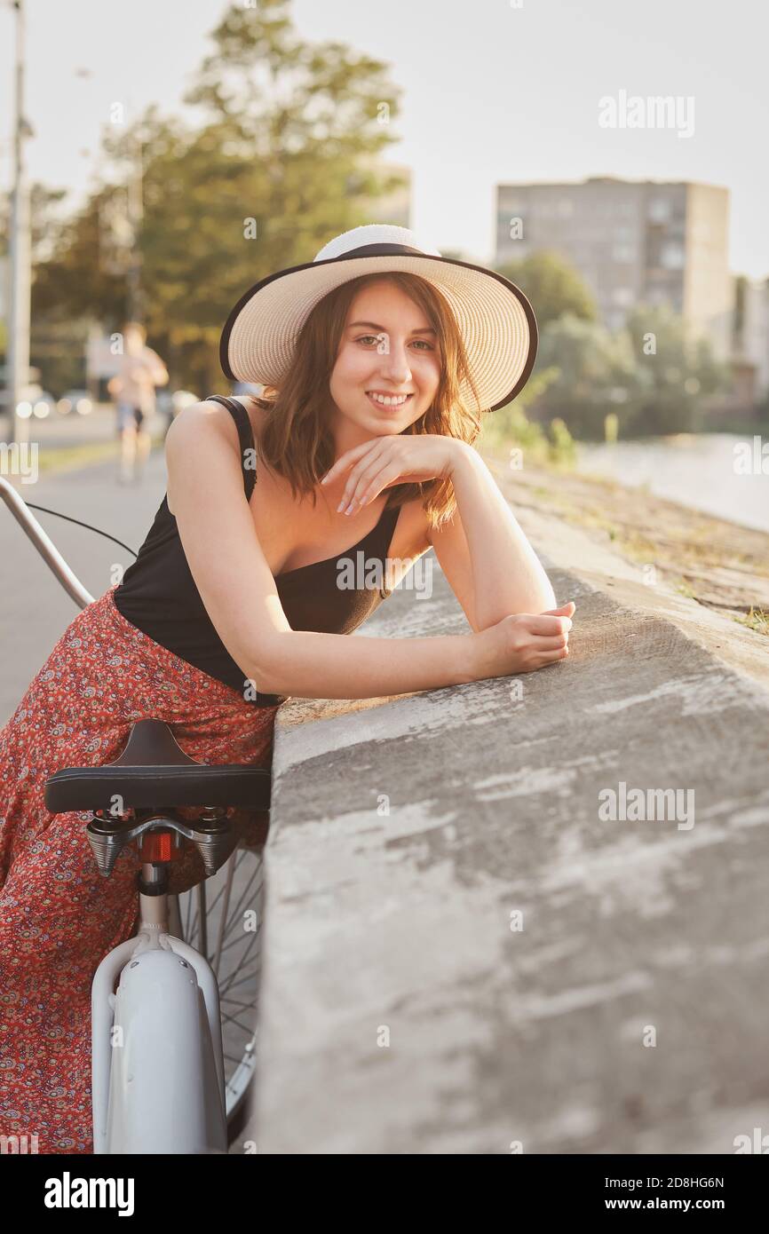 cute young woman cyclist resting under sunlight smiling Stock Photo - Alamy