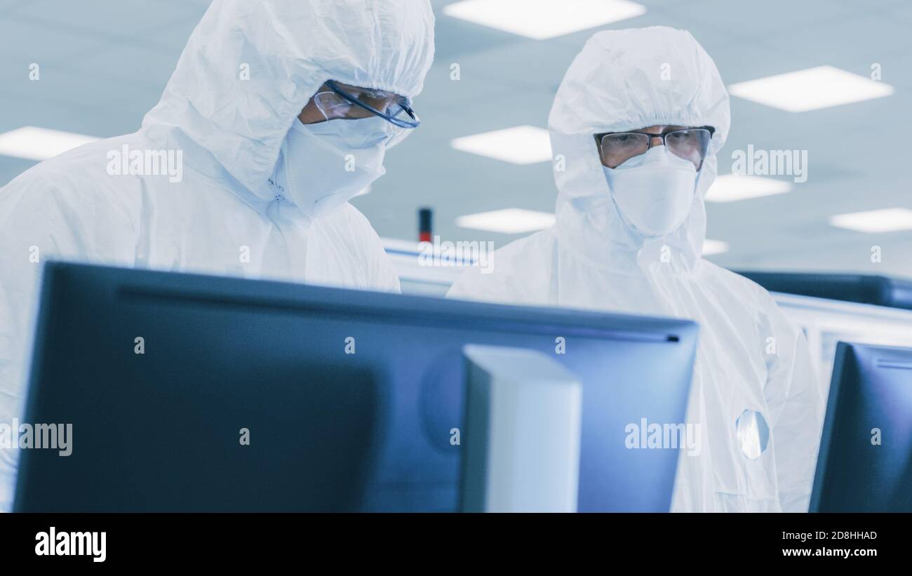 Two scientists in sterile suits hi-res stock photography and images - Alamy