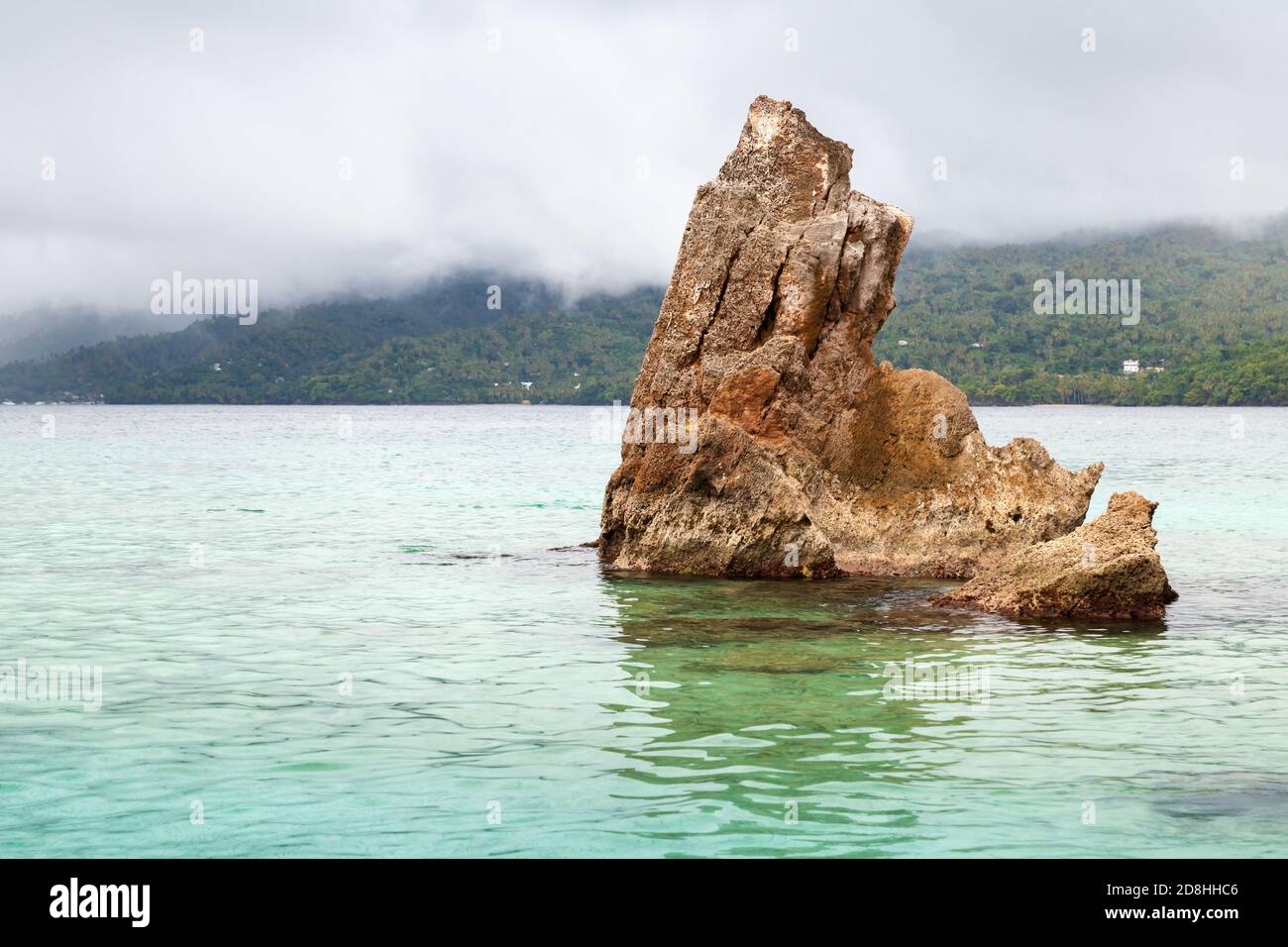 Samana bay landscape with small coastal rock in blue sea under cloudy ...