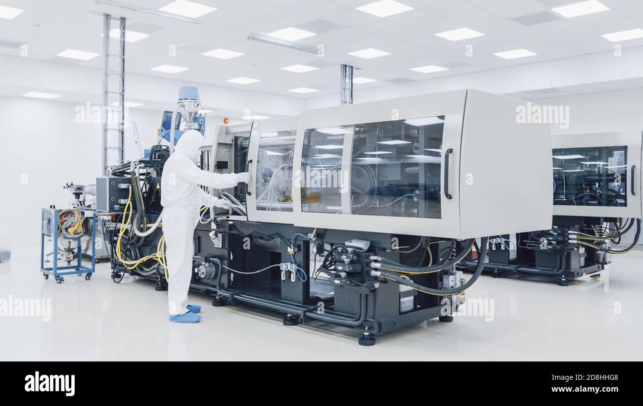 On a Factory Scientist in Sterile Protective Clothing Work on a Modern ...